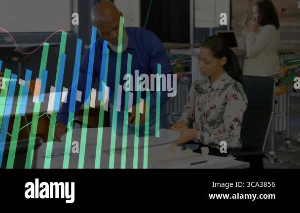 Three business professionals collaborating at desk in office, showing ...