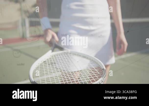 Female player balancing tennis ball on racket at outdoor court, with ...