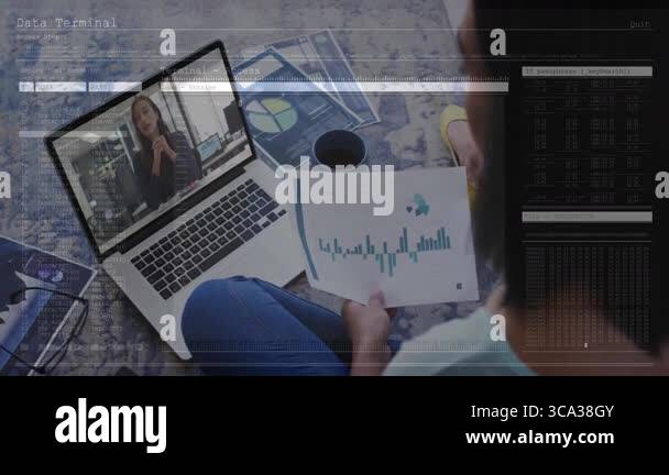 Data analyst sitting on carpet with laptop, holding chart while code ...