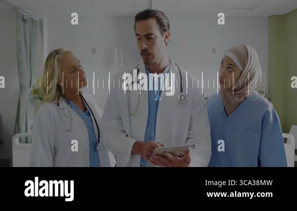 Medical team reviewing patient data in hospital room showing animated ...