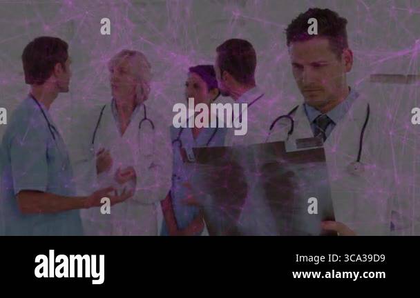 Medical team examining X-ray film in corridor, with animated ...
