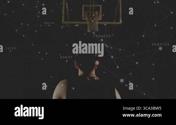 Male athlete raising basketball shooting toward hoop in gym, with data ...