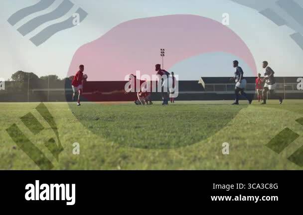 Red rugby ball carrier reacting tackle spill, diving recovering ball ...