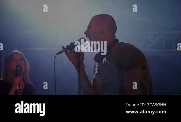 Female singer and male rapper performing music on stage, with animated ...