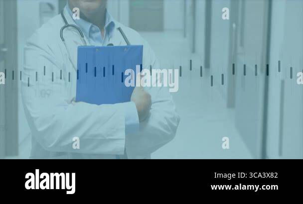 male doctor holding clipboard in hospital corridor, showing medical ...