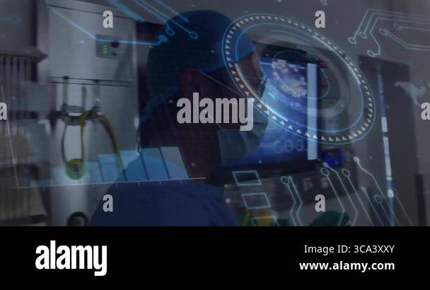 male surgeon standing in operating room, scanning monitors with ...