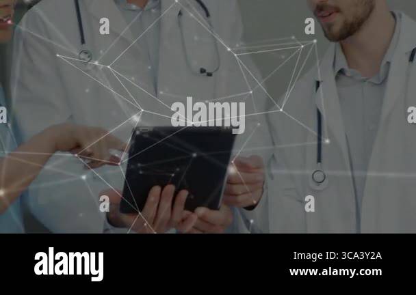 Healthcare professionals collaborating on tablet in hospital ...