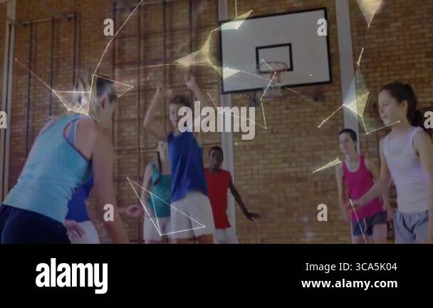 Group shooting and rebounding under hoop in school gym, with ...