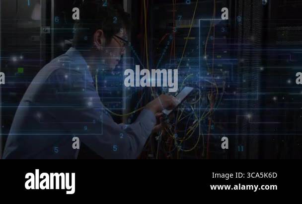Network engineer handling tablet while managing cables, showing glowing ...