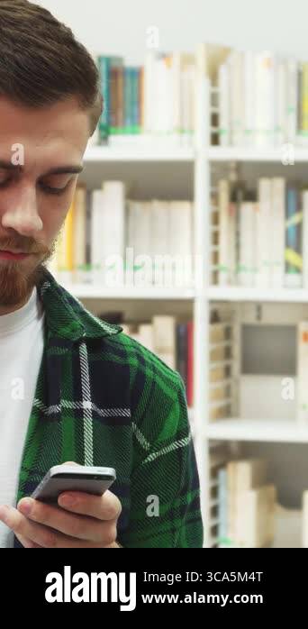 In a dynamic library brimming with colorful books, a young man with ...