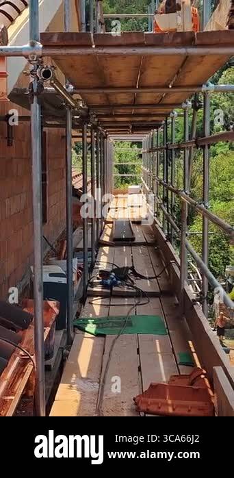 Comprehensive View of Residential Roof Repair Featuring Scaffolding and ...