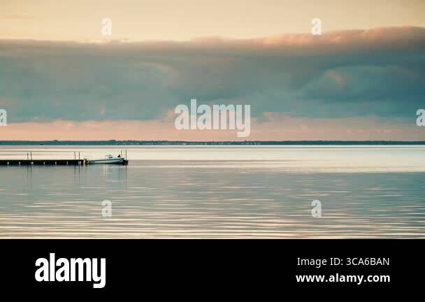 Seascape at evening with boat tied to wooden pier. Baltic sea, puck bay ...