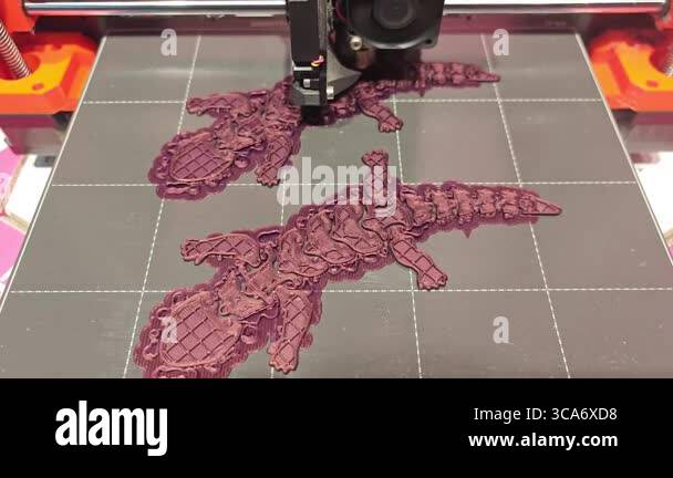 Printing parts of a pink lizard toy on a 3D printer. New technologies ...