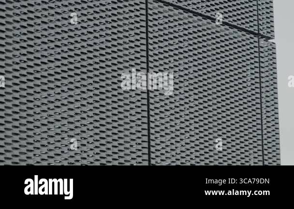 Close-up of a modern buildings facade with a unique, textured metal ...