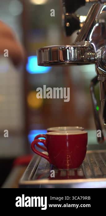 Pouring hot water to make Vietnam drip manual brew coffee on black cafe ...