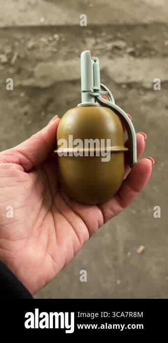 A training grenade held in a hand. Military training, handling of inert ...