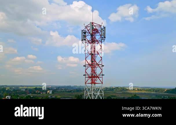 5g High Cell Tower Stands Against a Blue Sky in Rural Area Background ...