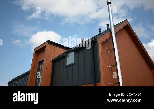 Stunning exterior view of a contemporary wooden and dark metal house ...