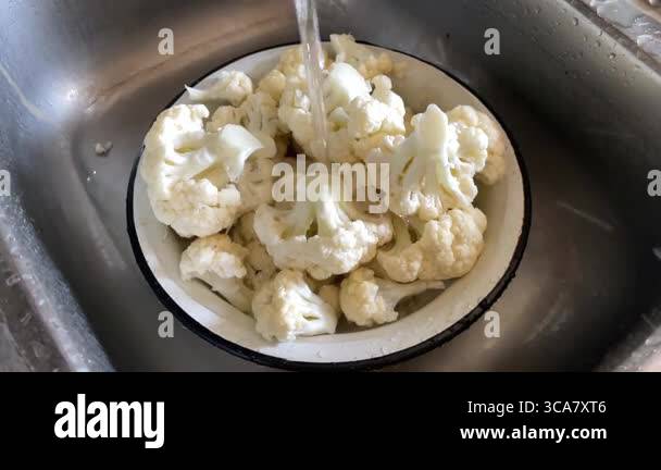 Washing fresh cauliflower under kitchen tap water Stock Video Footage ...