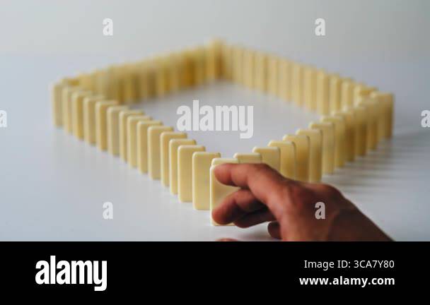 Man hand push domino on white surface closeup. Unrecognizable male ...