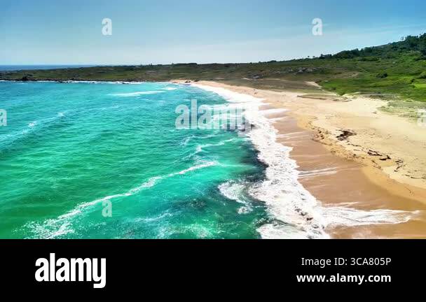 A stunning coastal scene shows clear turquoise waters and golden sands ...