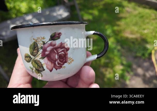 vintage metal mug. A hand is holding a traditional green metal mug from ...