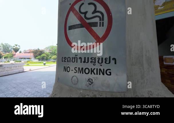 Close-up of a No Smoking sign mounted on a street pole, emphasizing ...