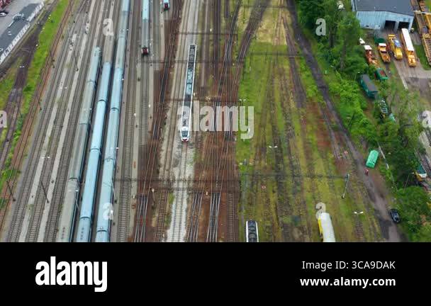 Aerial footage showing a electric city train moving next to the train ...