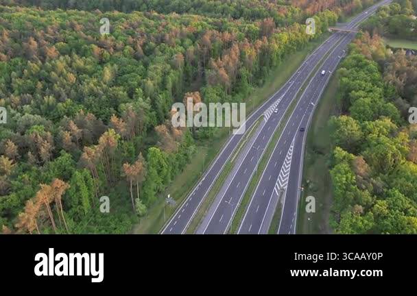 Aerial View of Highway and Bridge Over Highway in Forest at Sunset ...