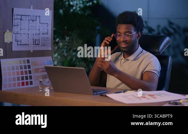 African American business man designer architect businessman talk mobile phone in night office ...
