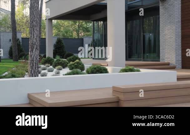Wooden terrace next to a modern house. Modern residential design with ...