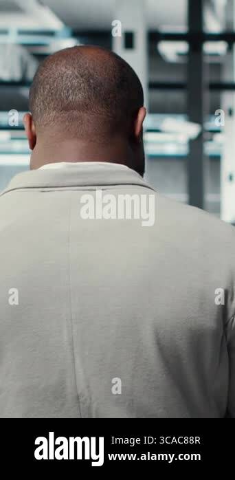 Vertical video Admin walking in high tech data center facility ...