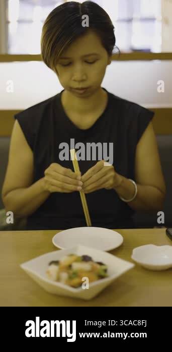 Woman Is Using Chopsticks To Pick Up Food, Video footage for ...
