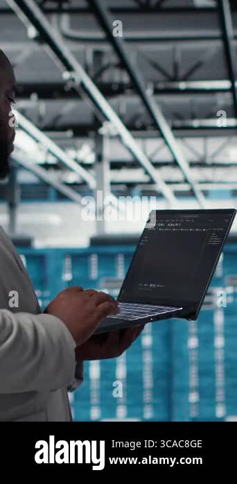 Vertical video Server room infrastructure engineer scripting automated workflows using software ...