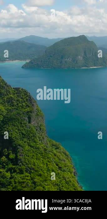 Tropical Island surrounded by blue sea. El Nido. Blue sky and clouds ...