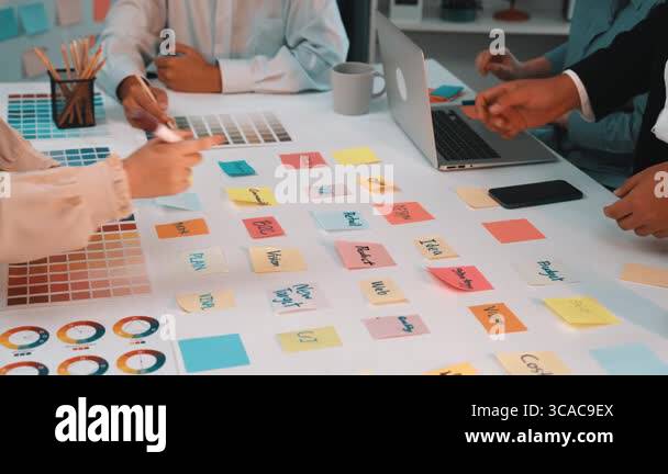 A diverse team engaged in a creative brainstorming session, analyzing ...