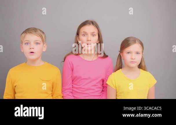 Three children are vividly displaying shock and surprise, showcasing a ...