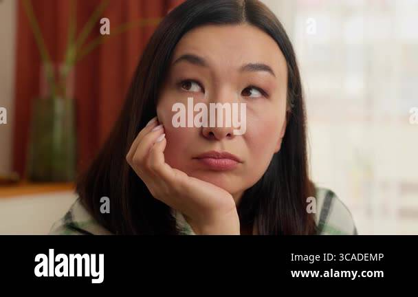 Close up face thoughtful puzzled Korean Japanese businesswoman business ...