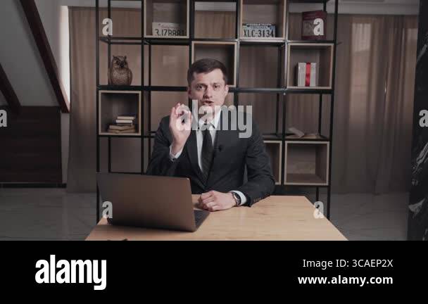 Male in dark suit looking at camera and emotional talking gesturing ...