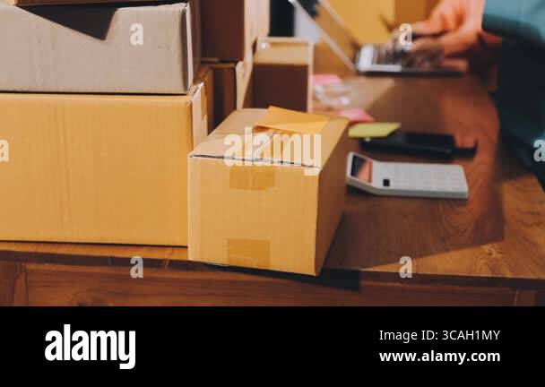 delivery service. man with cardboard boxes and laptop on the background ...