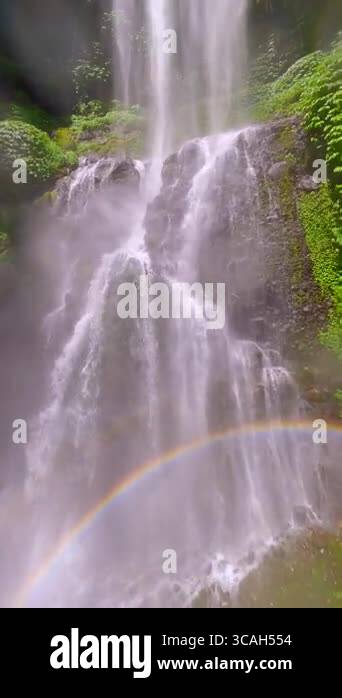Slow motion FPV drone shot soaring above the splashing Sekumpul ...