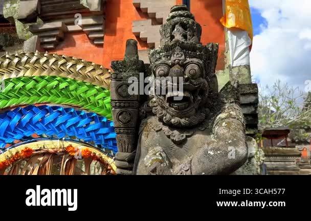 Close-up of traditional Balinese stone guardian statue with colorful ...