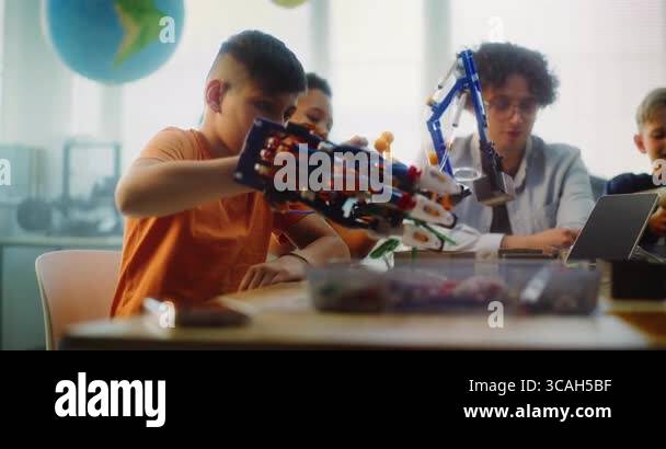 Diverse Group of Children and Young Teacher Working Together on STEM ...