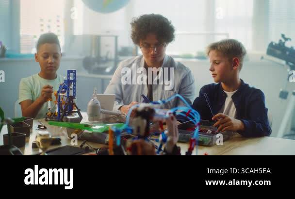 Diverse Group of Children and Young Teacher Working Together on STEM ...
