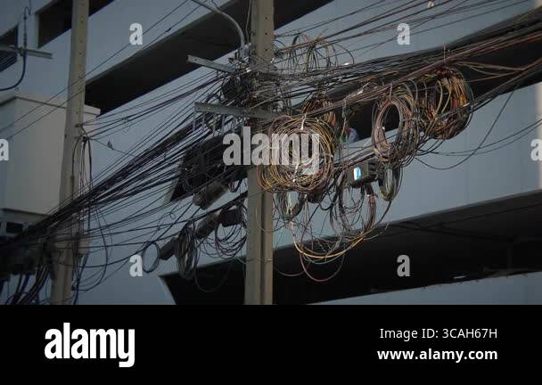A vivid display of tangled power lines and cables, highlighting the ...