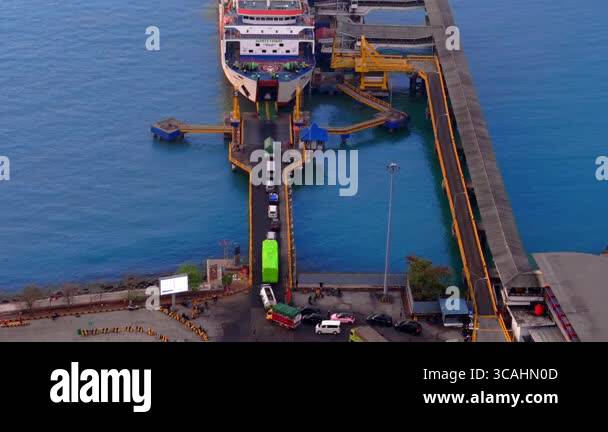 High-angle aerial static shot captures a large ferry docked at a pier ...