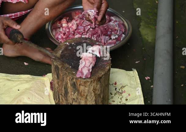 Chopping goat meat. Fresh raw or uncooked goats mutton cutting from ...