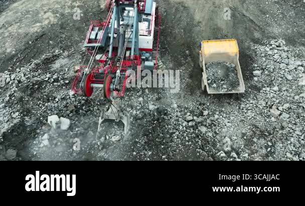 Large excavator loading rocks into dump truck at quarry Stock Video ...