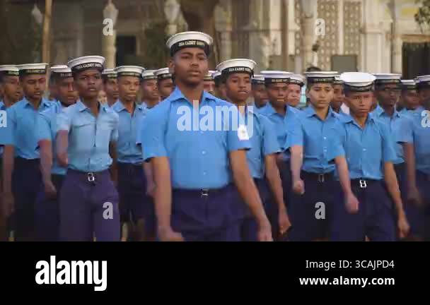 Boys in blue uniforms march in formation, performing synchronized arm ...