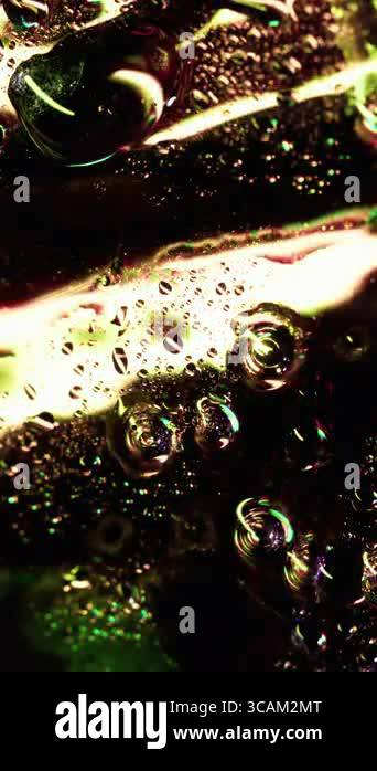 Vertical video. Surface dew. Wet glass. Color illuminated shiny area ...
